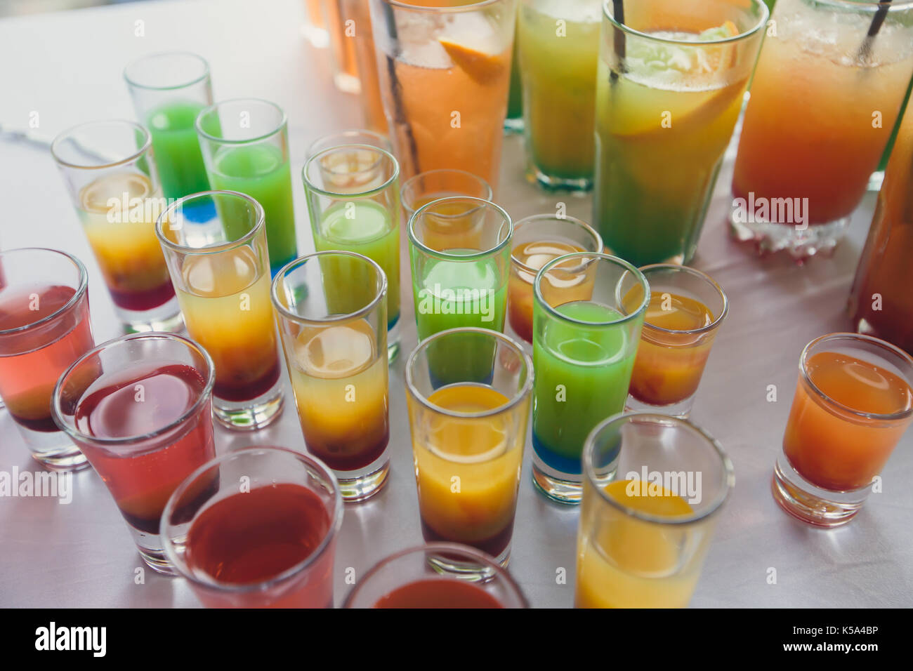 Beautiful line of different coloured cocktails on a open air party ...