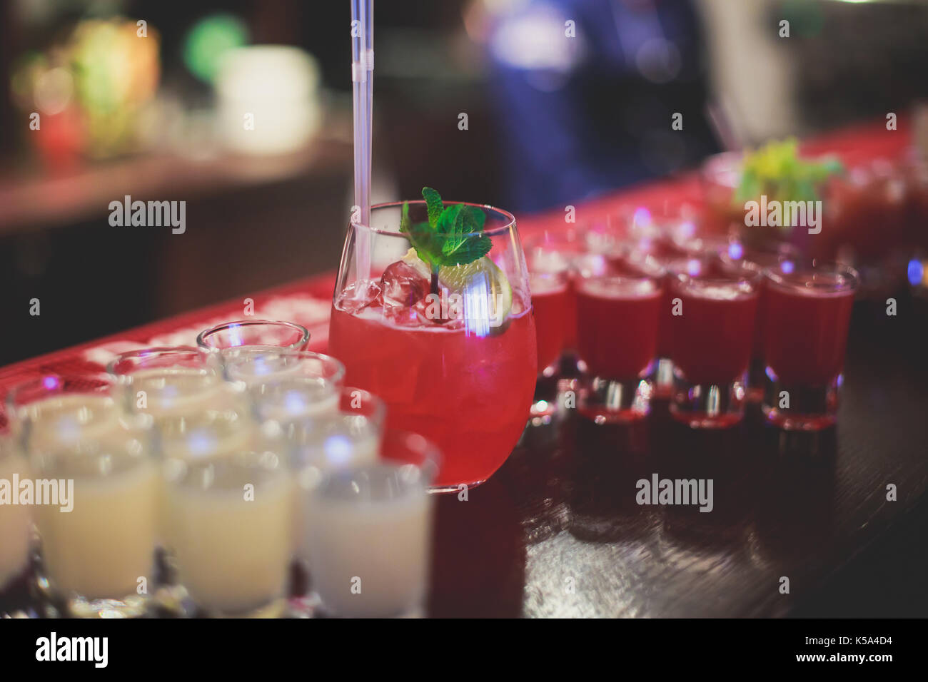 Beautiful line of different coloured cocktails on a open air party ...