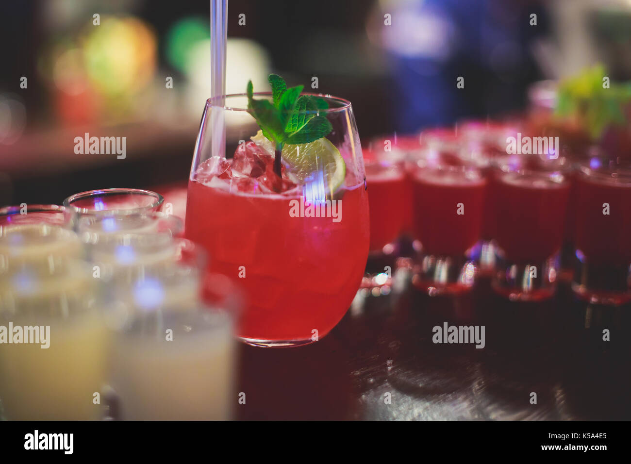 Beautiful line of different coloured cocktails on a open air party ...