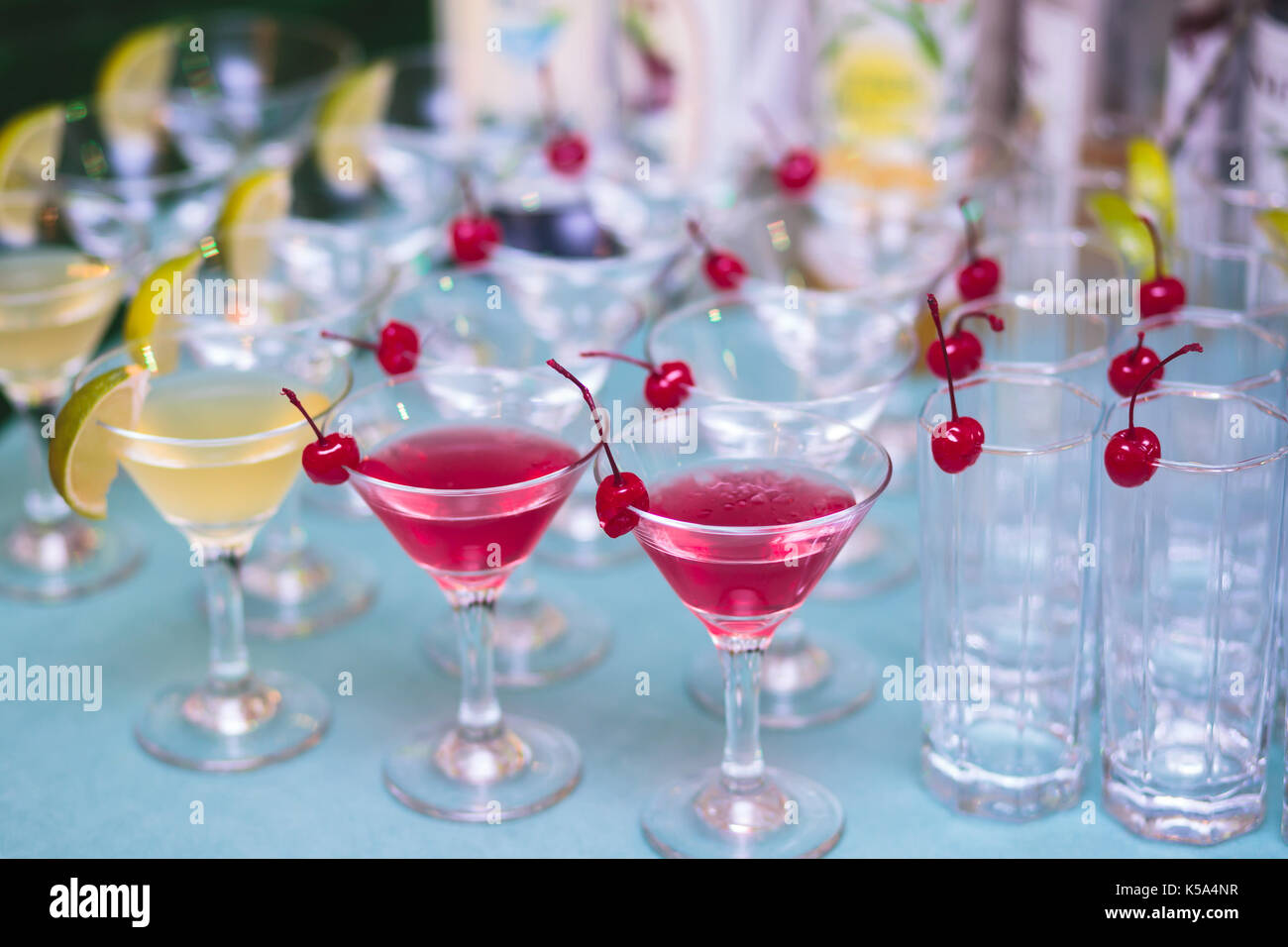 Beautiful line of different coloured cocktails on a open air party ...