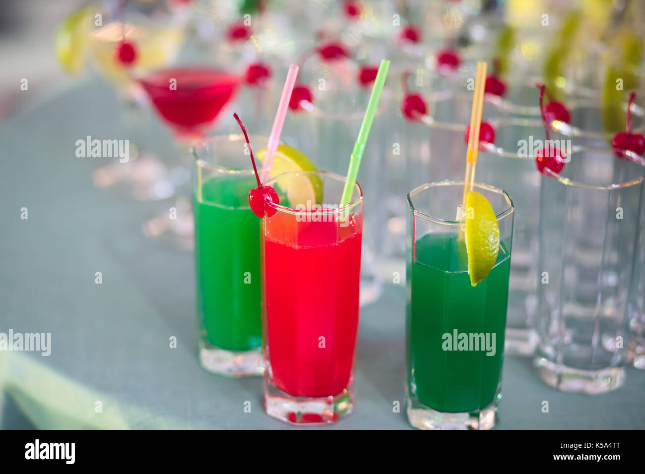 Beautiful line of different coloured cocktails on a open air party ...