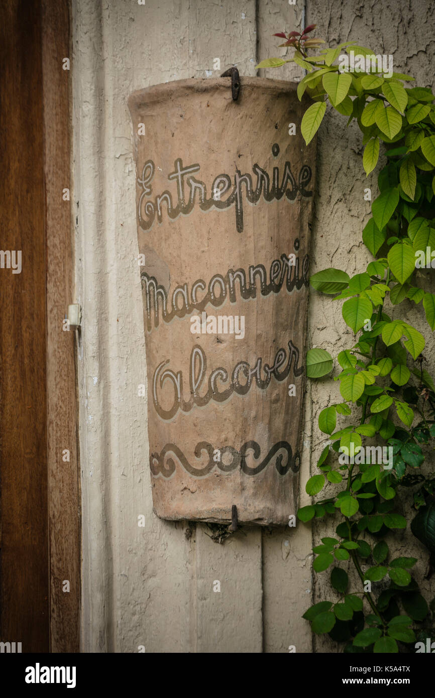 Old sign for a masonry business on building, Tourbes, Herault, France ...