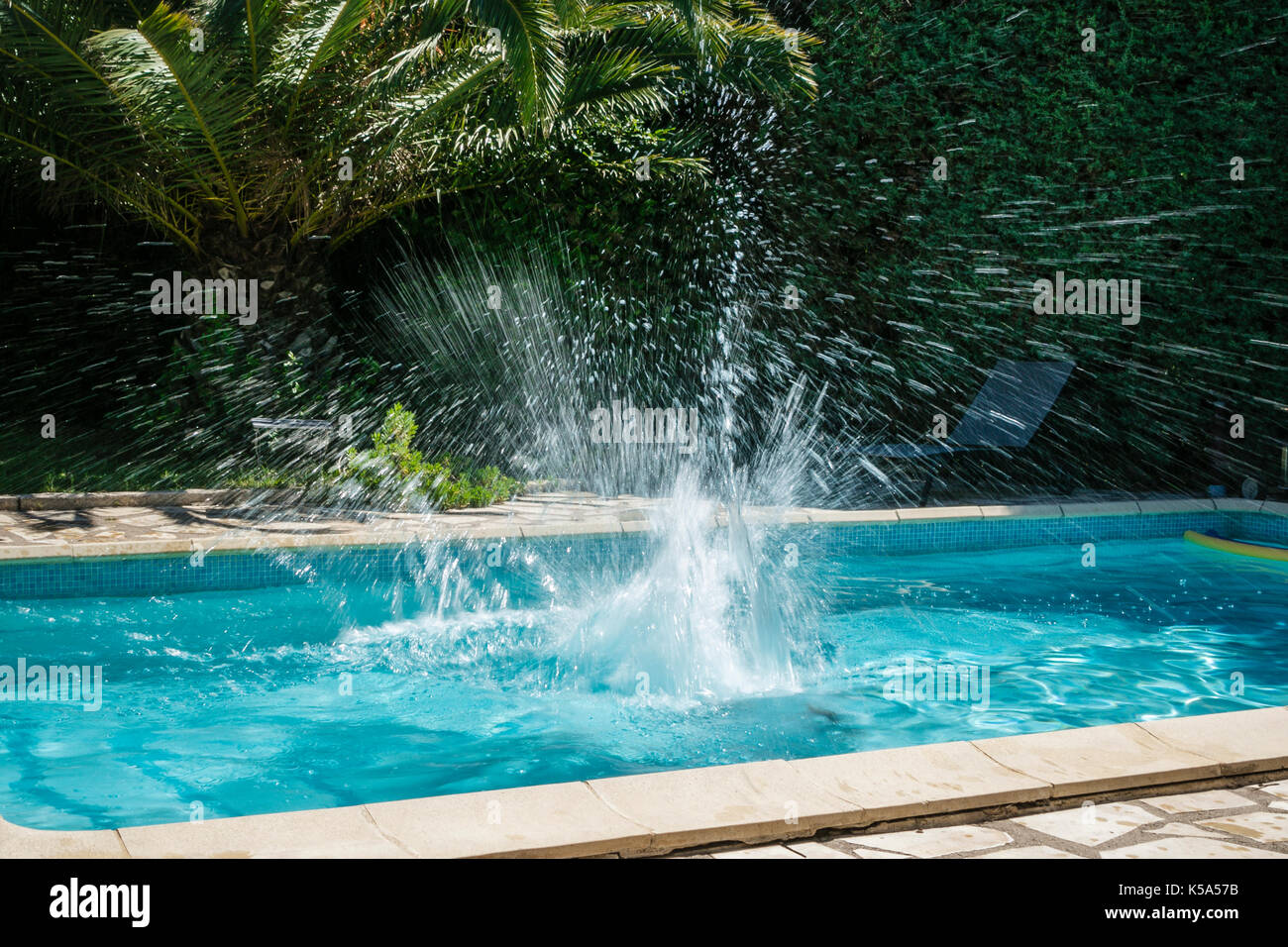 Splashes from diver in outdoor swiming pool Stock Photo - Alamy