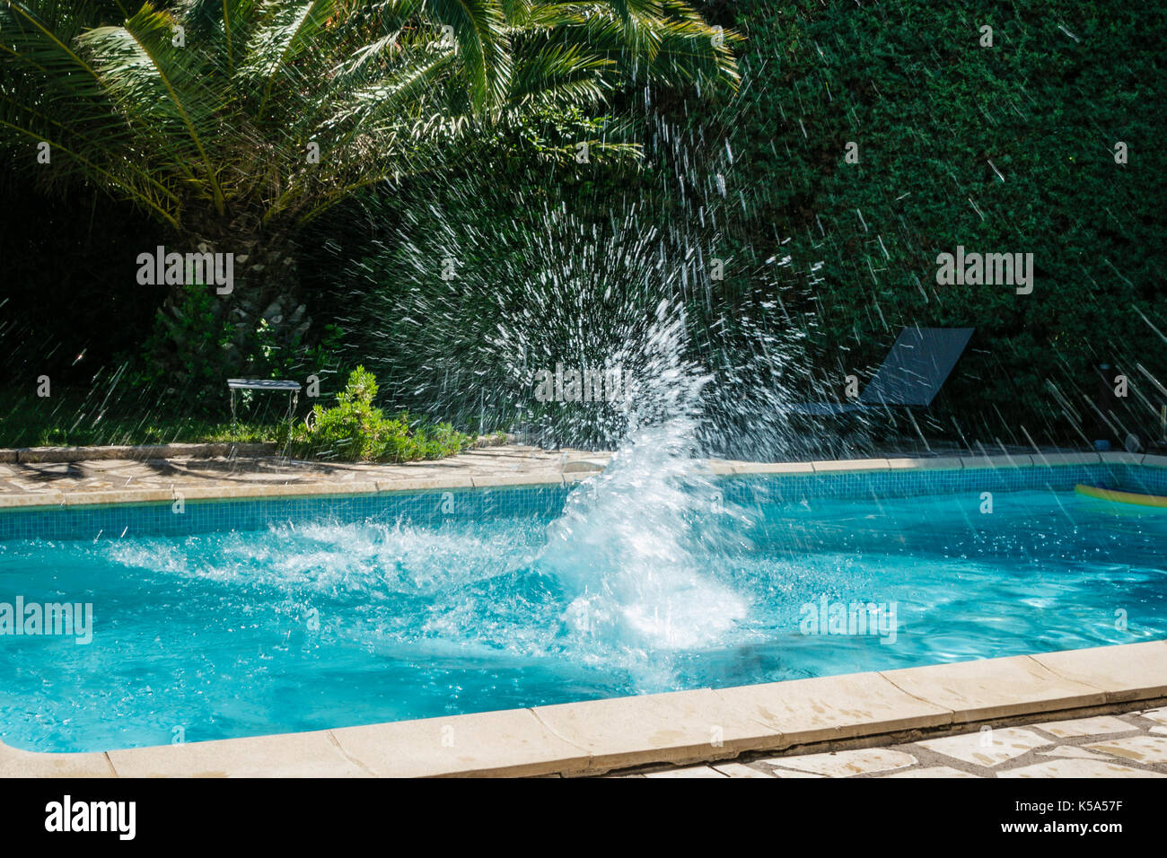 Splashes from diver in outdoor swiming pool Stock Photo - Alamy