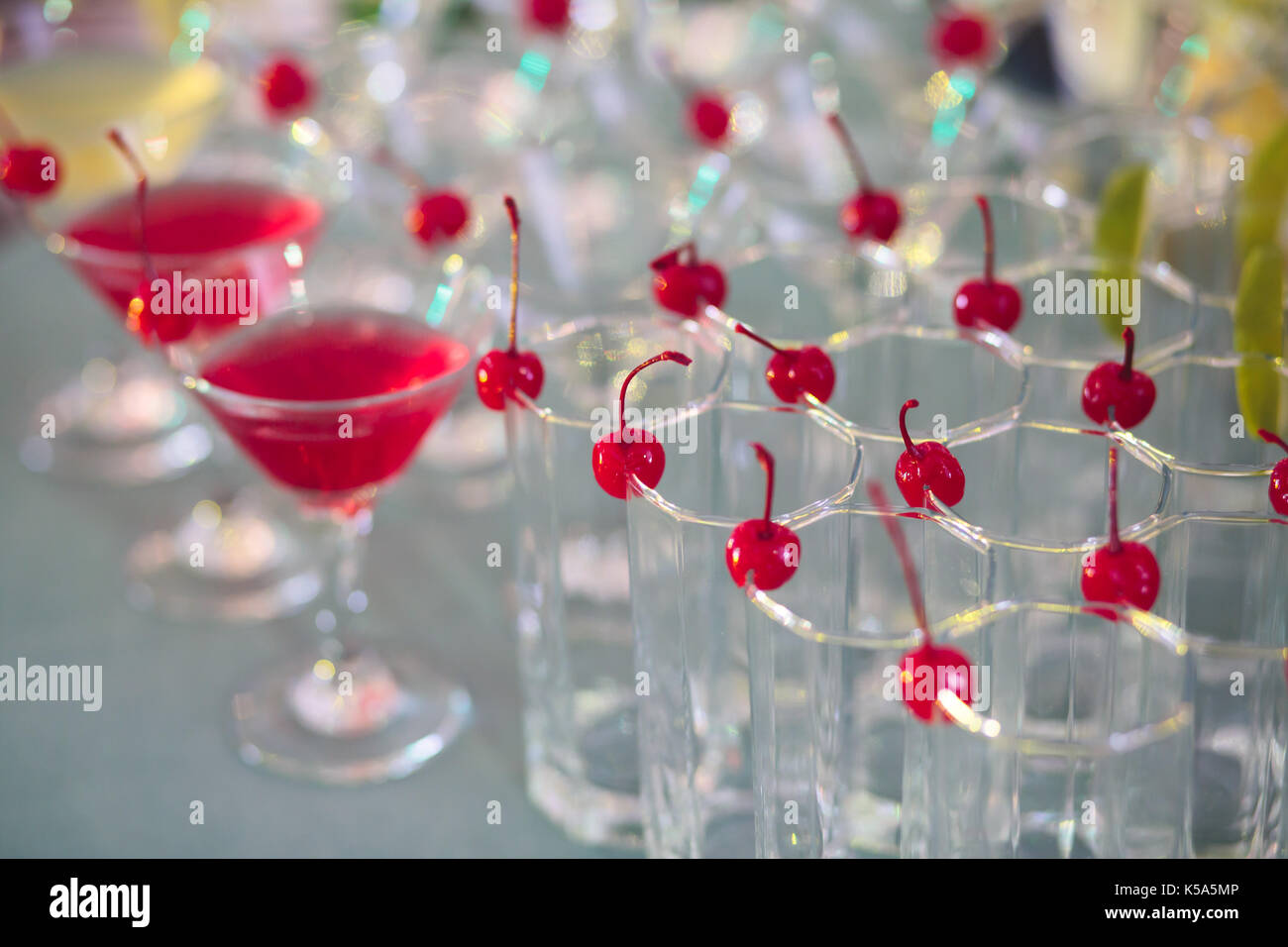 Beautiful line of different coloured cocktails on a open air party ...