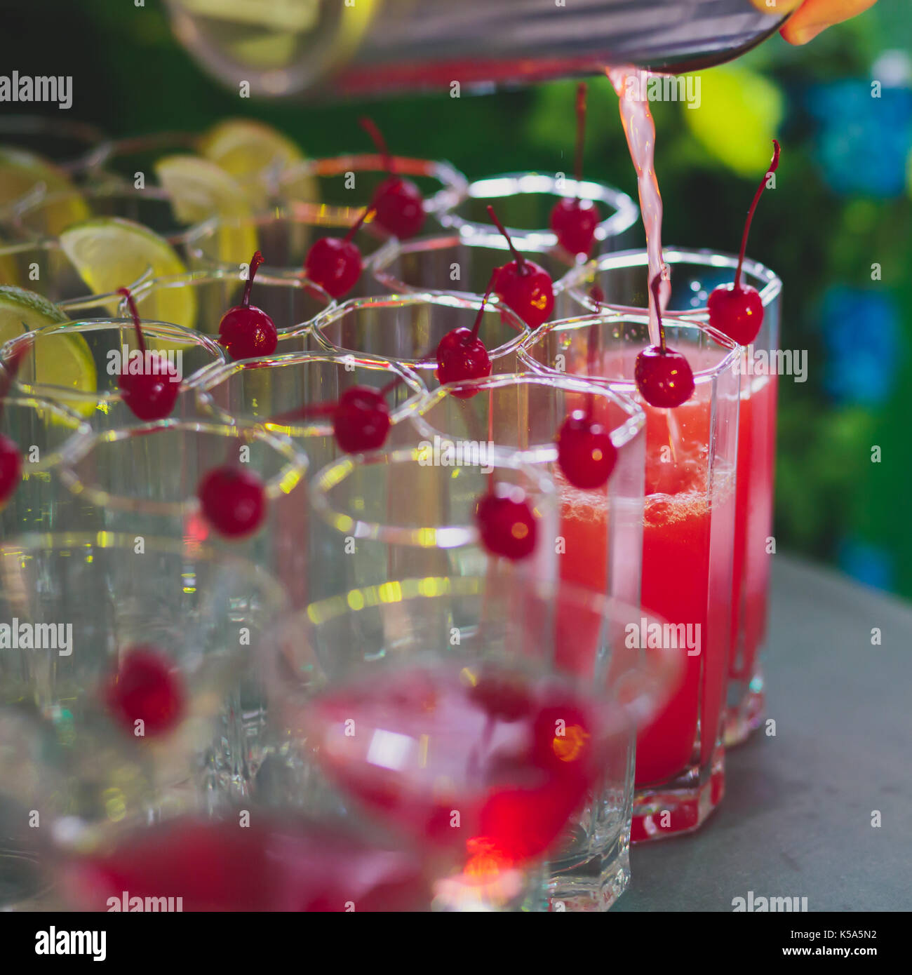 Beautiful line of different coloured cocktails on a open air party ...