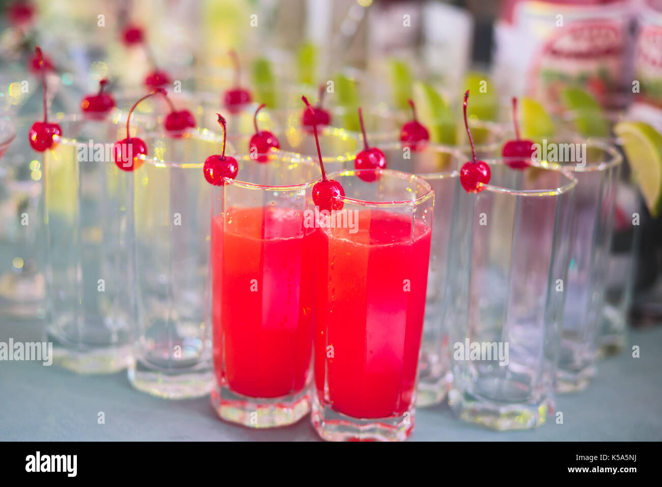Beautiful line of different coloured cocktails on a open air party ...