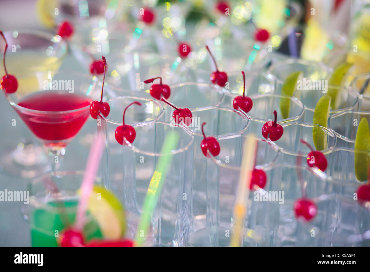 Beautiful line of different coloured cocktails on a open air party ...