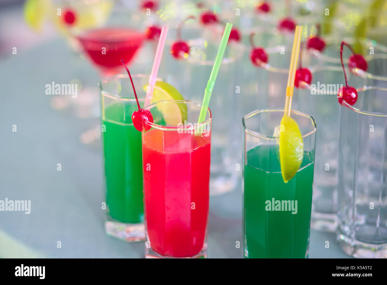 Beautiful line of different coloured cocktails on a open air party ...