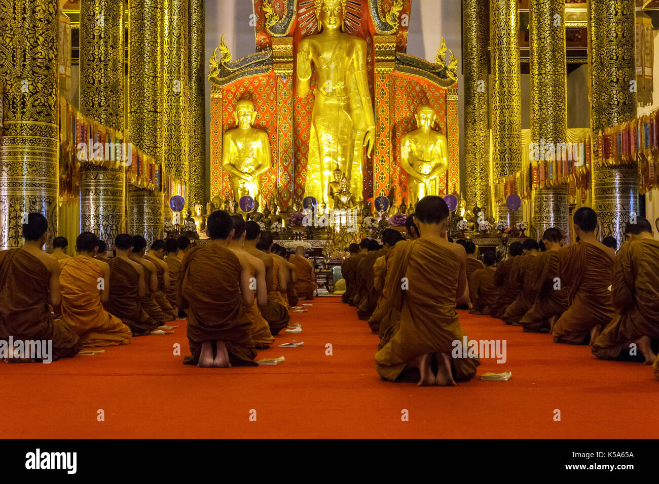 Buddhist monks praying in temple hi-res stock photography and images ...