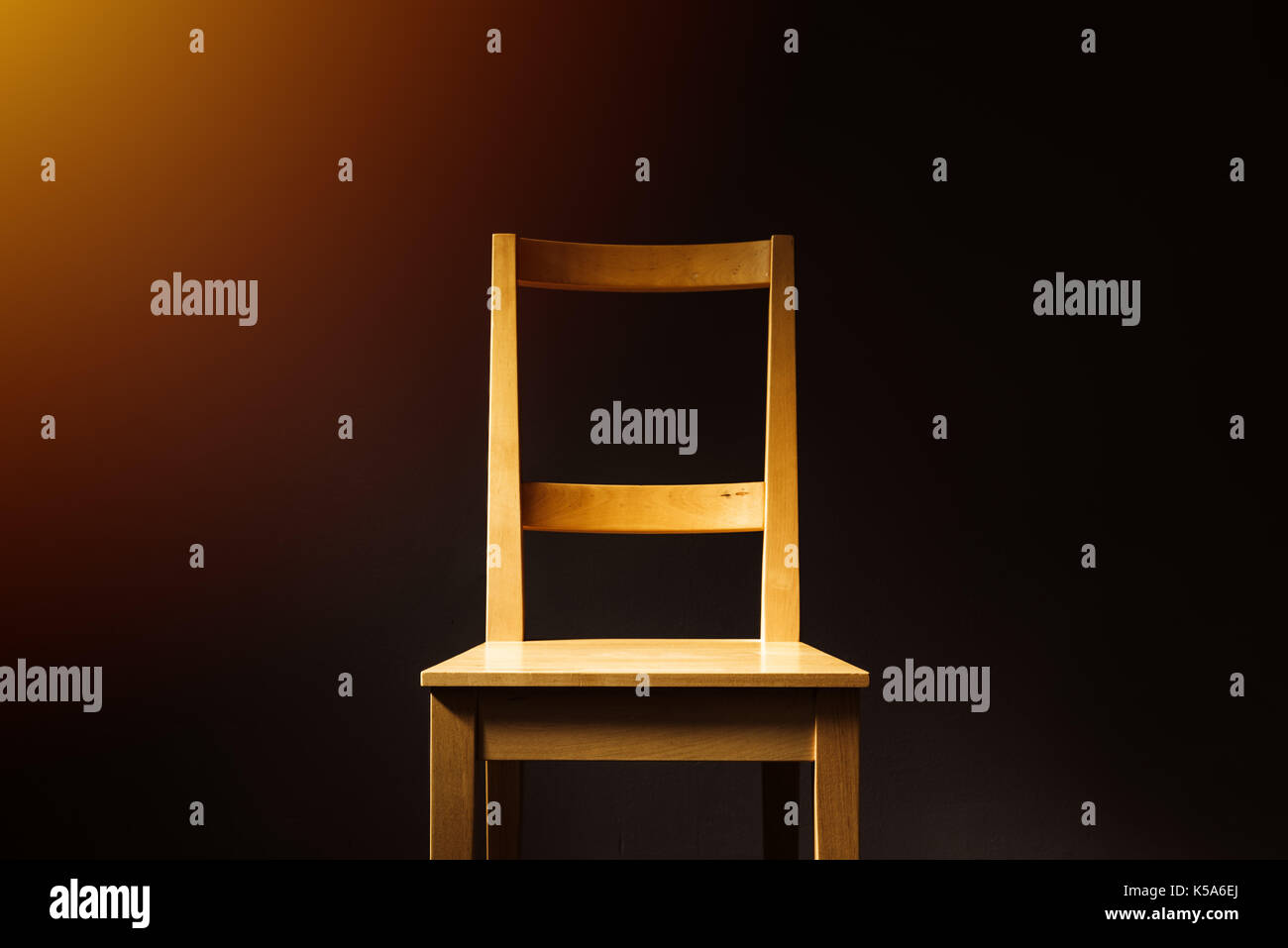 Empty wooden chair in dark room as a background for business interview ...