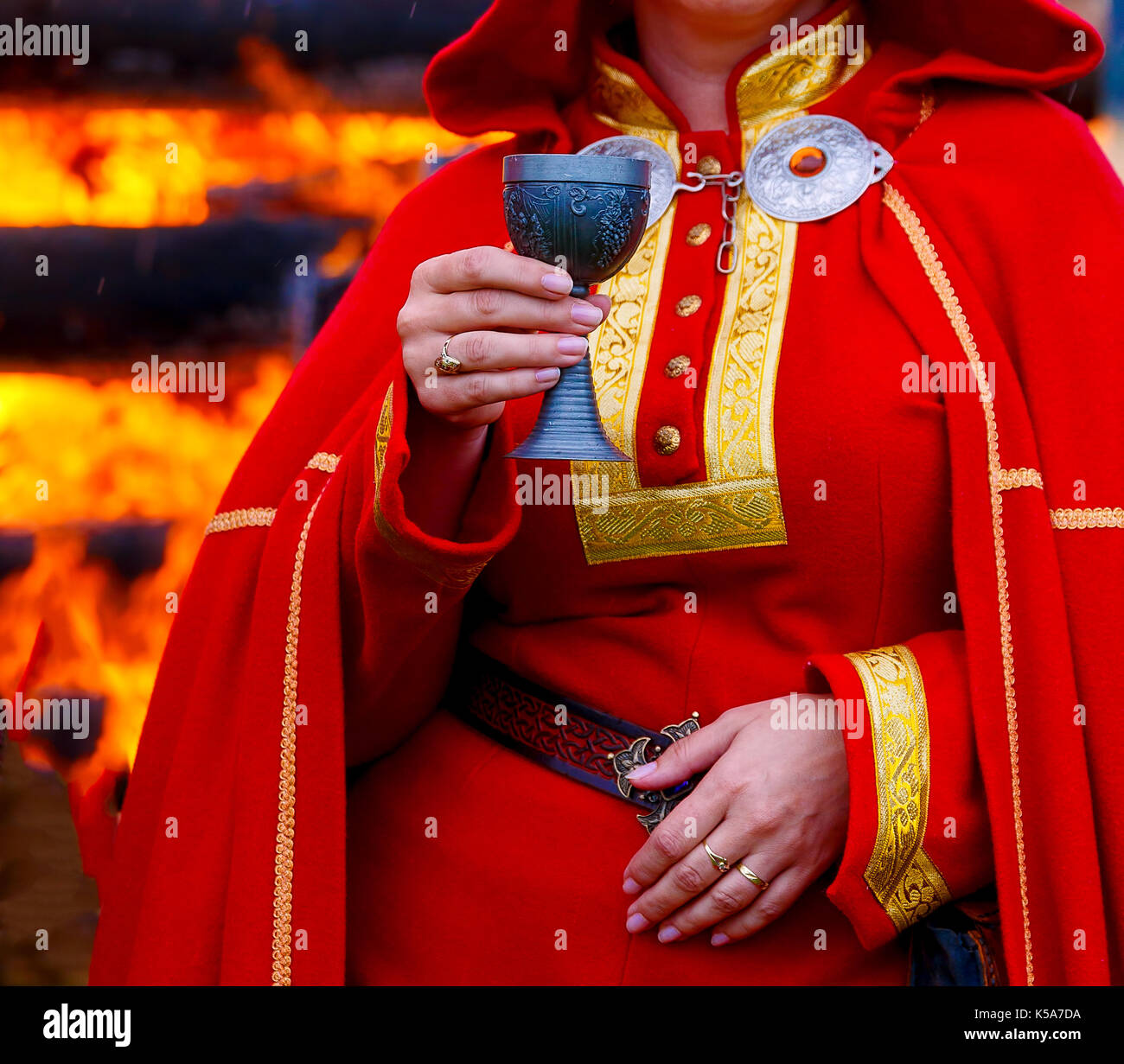 beautiful medieval ornamental cup in the hand of lady in historic dress ...