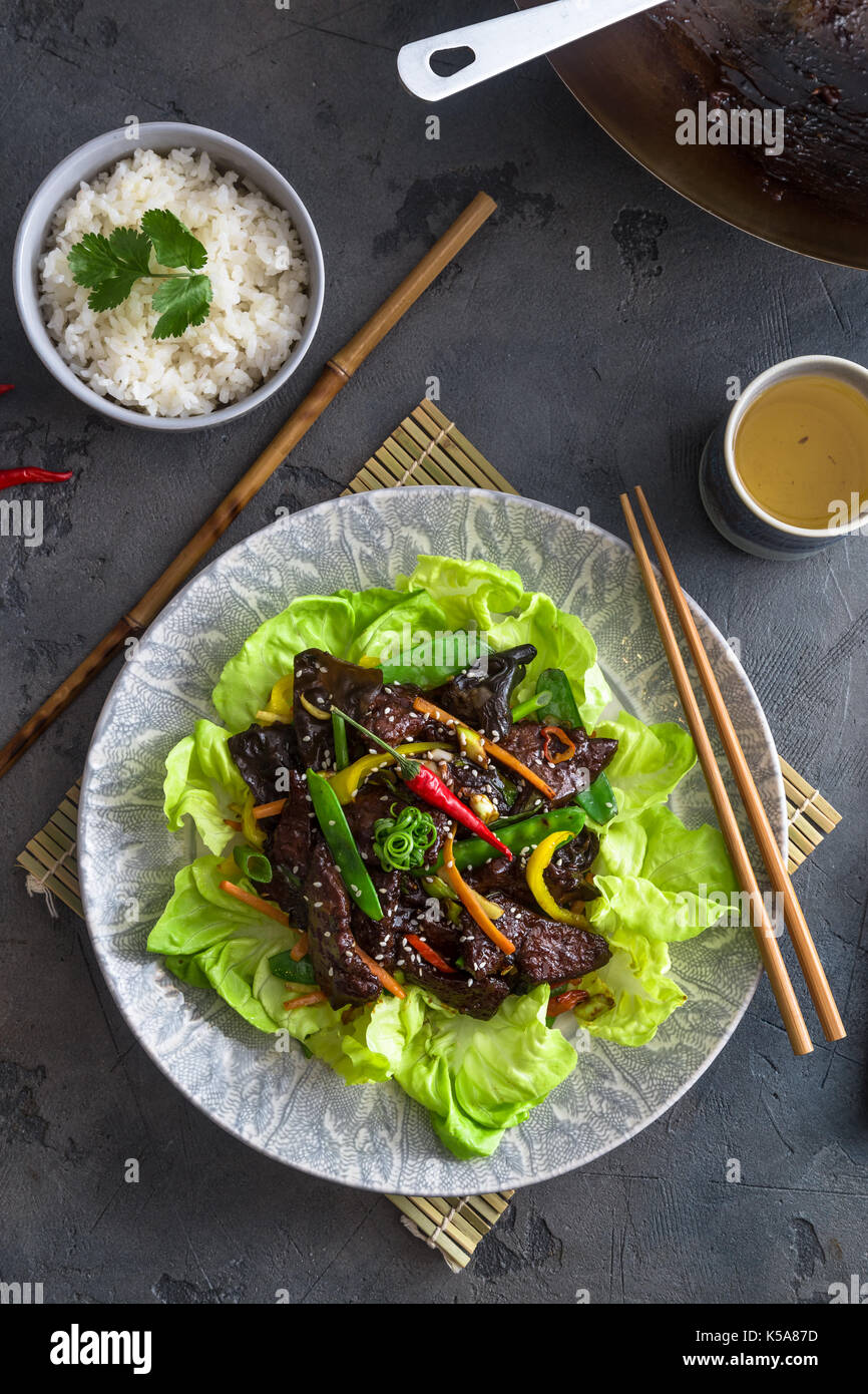 Asian stir fried chicken liver with bowl of rice and green tea Stock ...