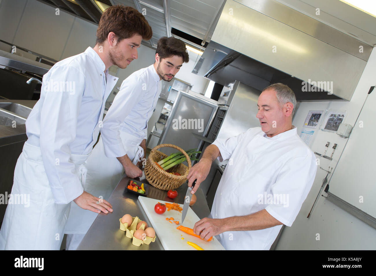 chef supervising trainees cooking Stock Photo - Alamy