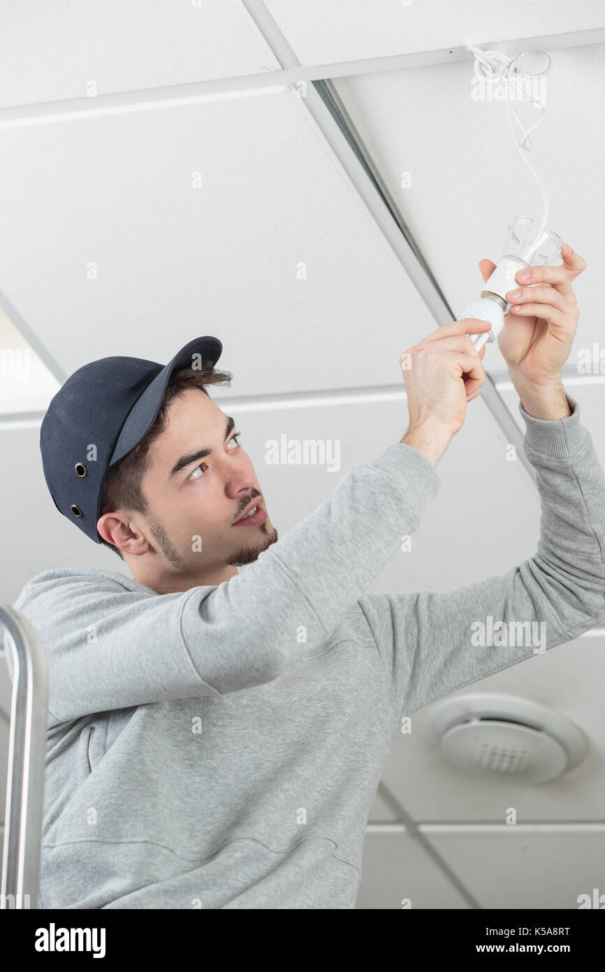 electrician man worker installing ceiling fluorescent lamp Stock Photo ...