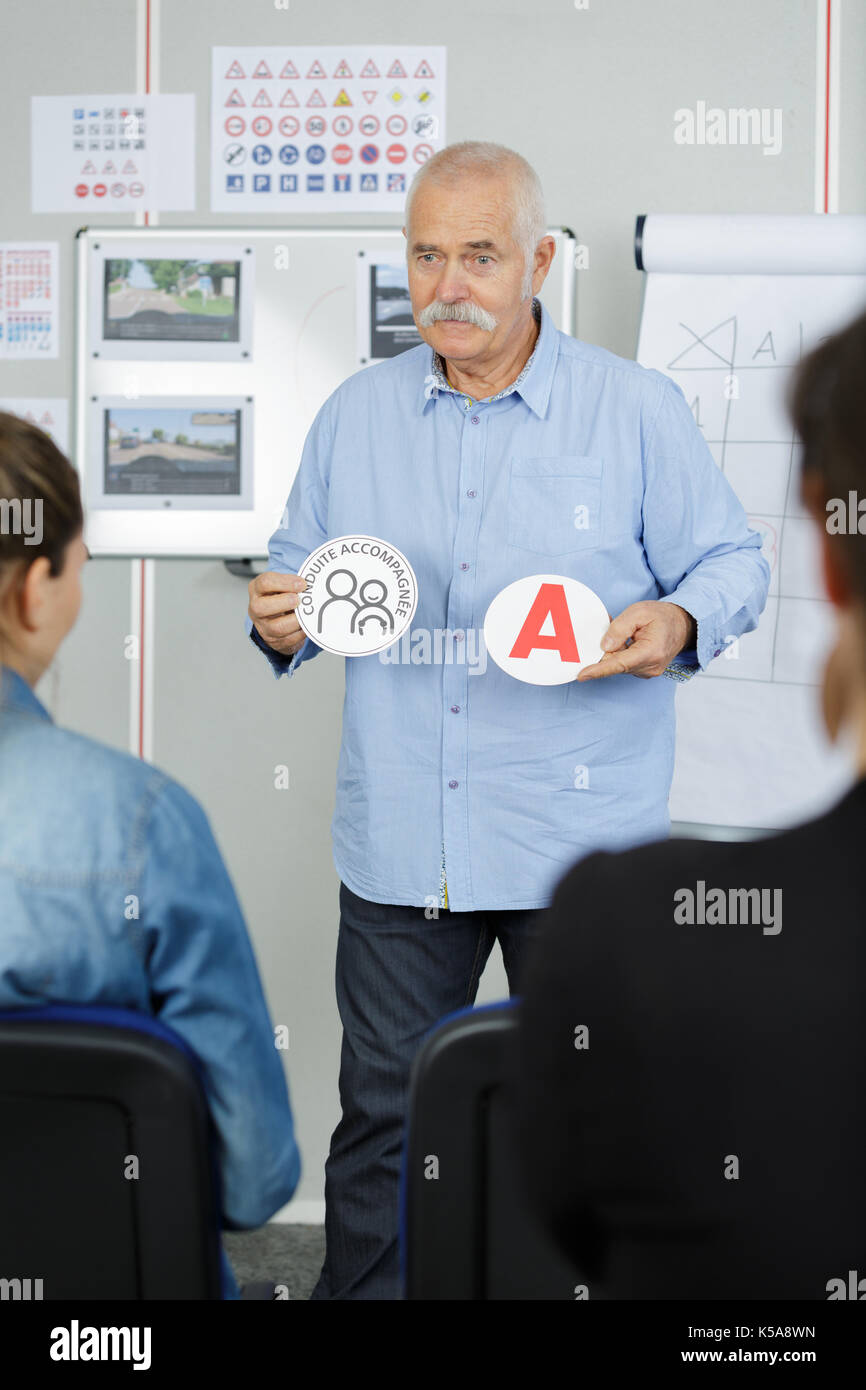 traffic regulations concept - teacher showing stop sign Stock Photo - Alamy