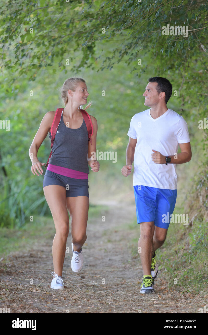 healthy fit sportive couple running in nature Stock Photo - Alamy