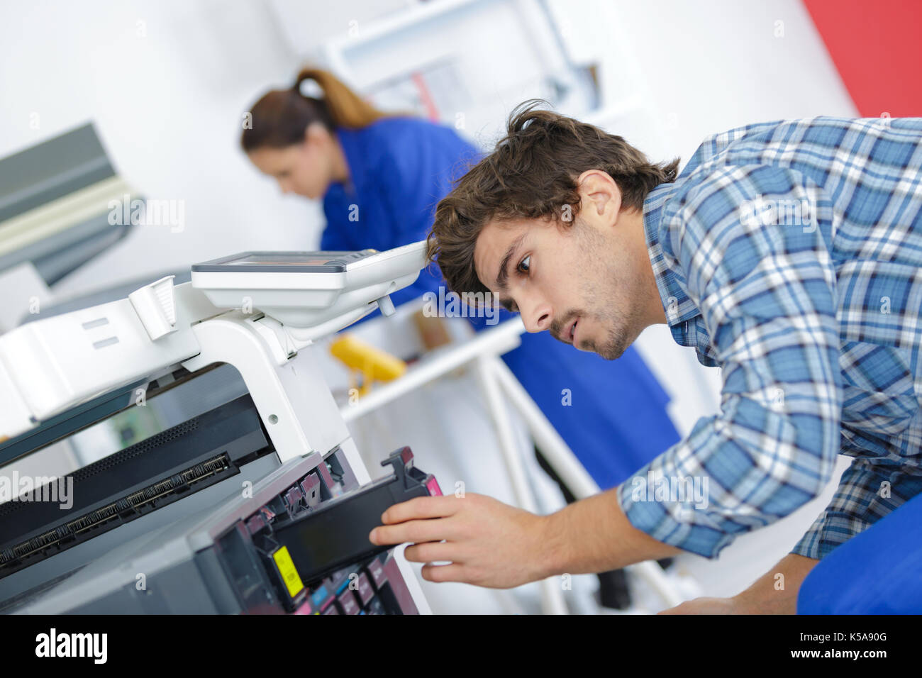 man technician repairing a printer at business place at work Stock ...