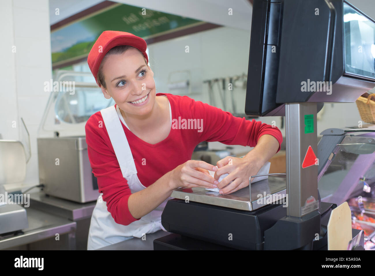 female cashier at sales desk of butcher Stock Photo - Alamy