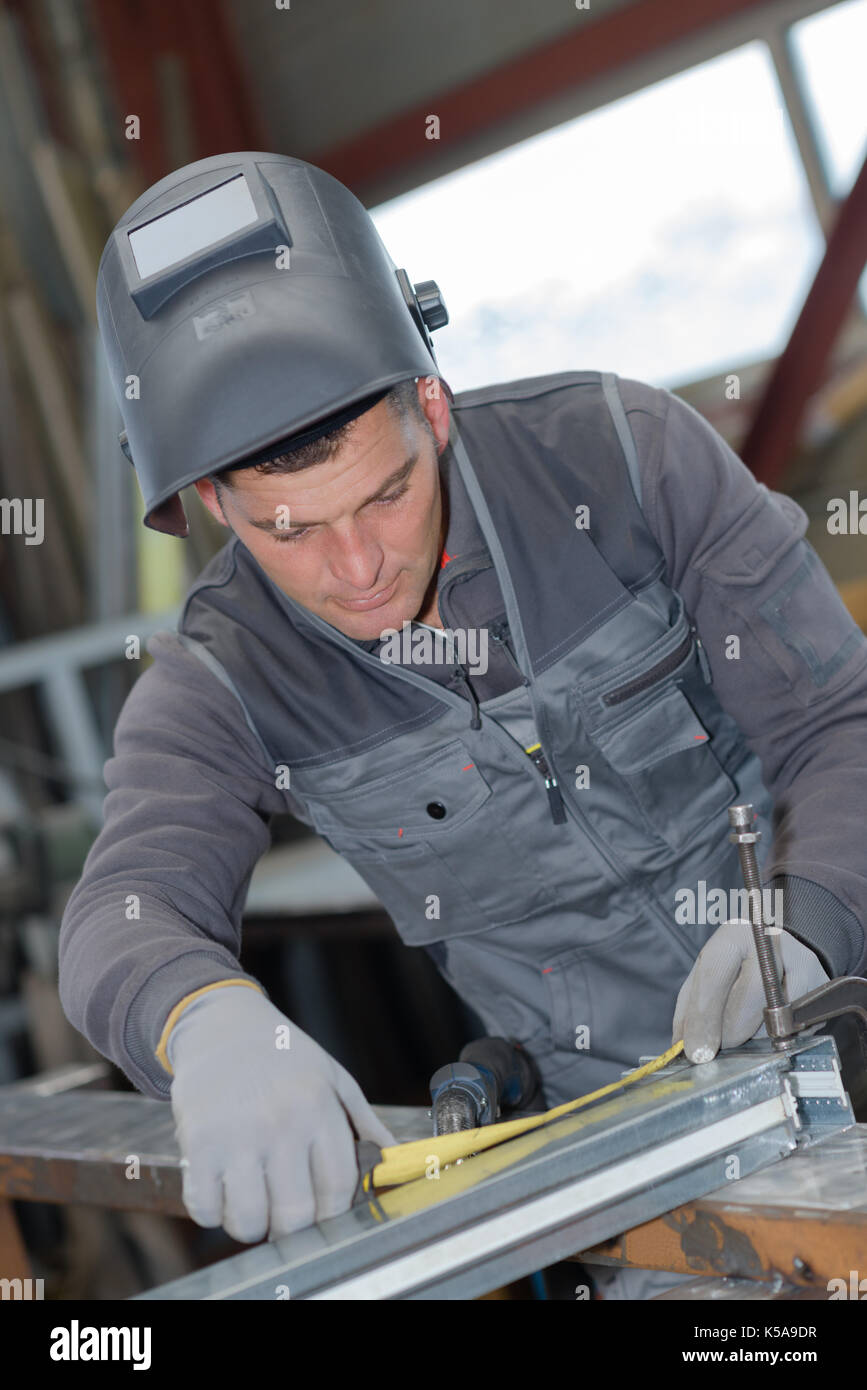 welder man measuring part in the workshop Stock Photo - Alamy