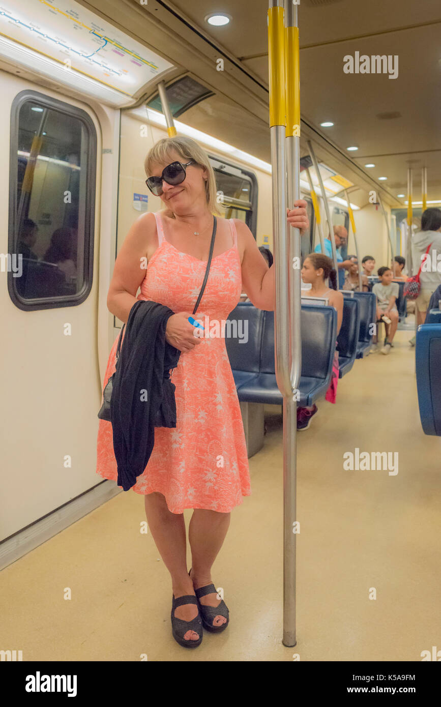 Woman on LRT skytrain subway transit system, Vancouver, British ...