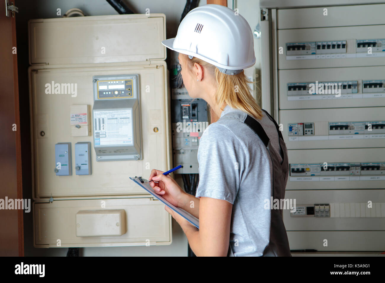 electrician woman solving problem on electrical board Stock Photo - Alamy