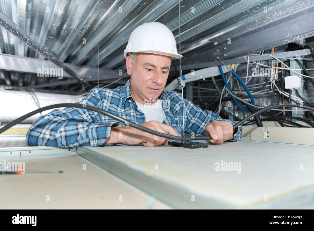 Electrician wiring inside ceiling hi-res stock photography and images ...