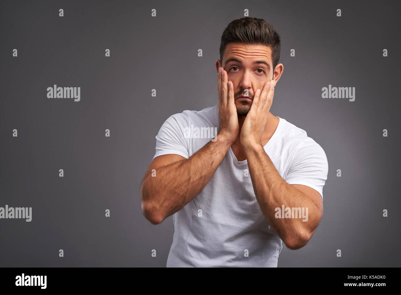 A handsome young man checking the skin on his face Stock Photo - Alamy