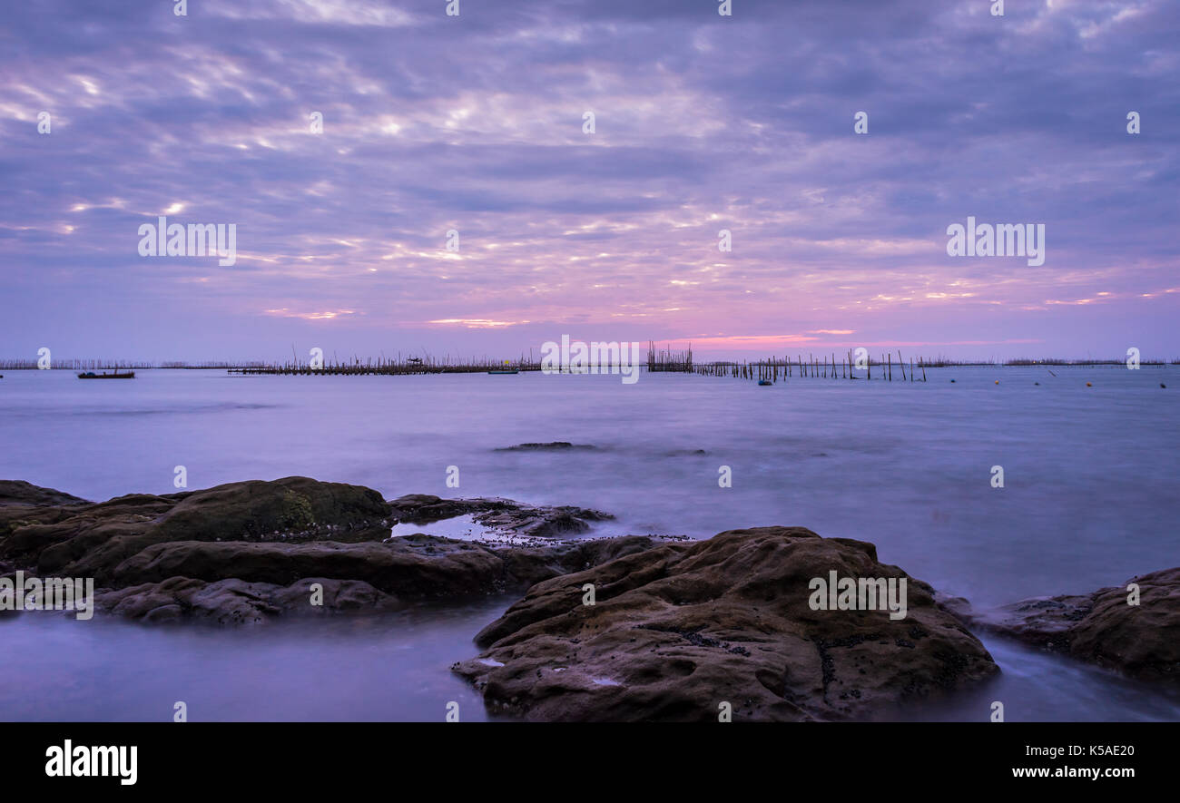 Ocean at sunset time in Thailand, slow shutter speed give a beautiful ...