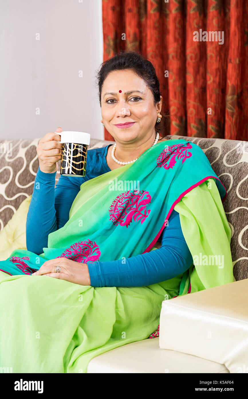 1 Indian senior woman sitting sofa Drinking morning Tea at home Stock ...