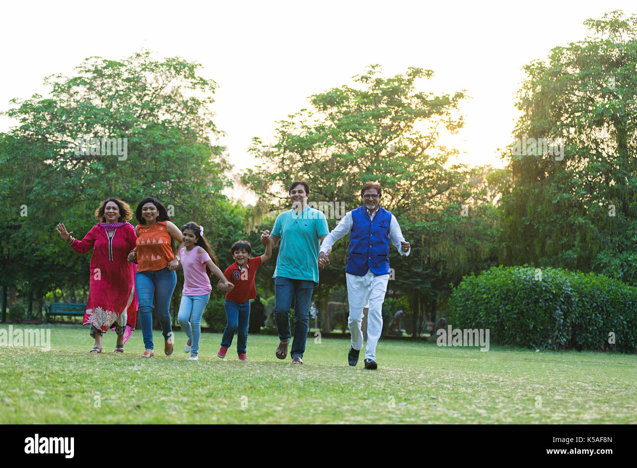Happy Big Family Hands Holding Running Park Having Fun Stock Photo - Alamy