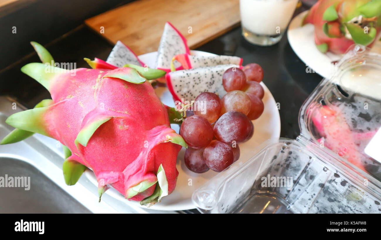 dragon fruit and grape in the dish Stock Photo - Alamy
