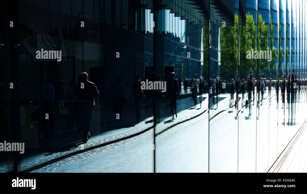Reflection of commuters walking past building in central London Stock ...