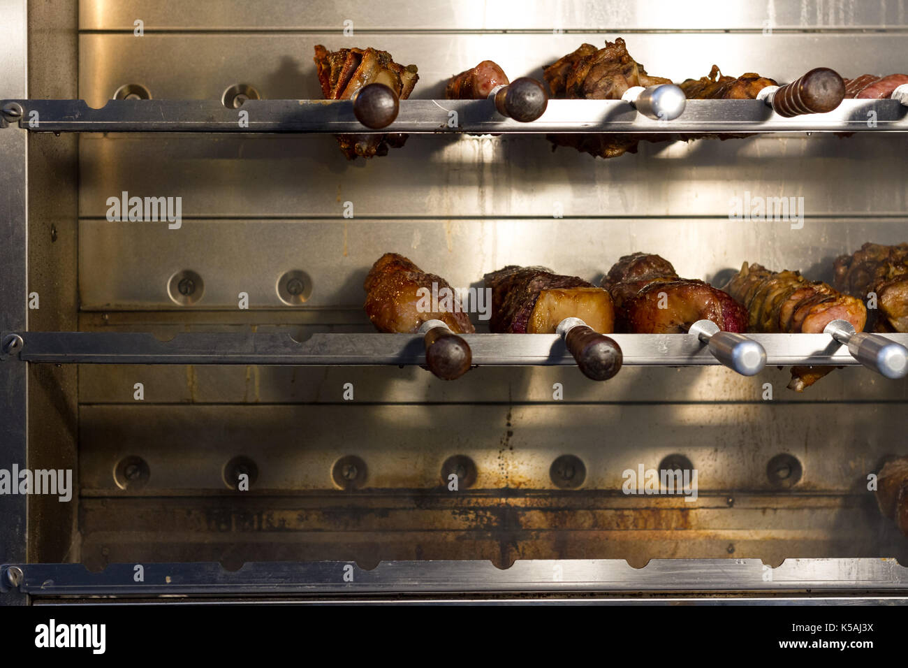 Preparation of spit meat in roast Stock Photo - Alamy