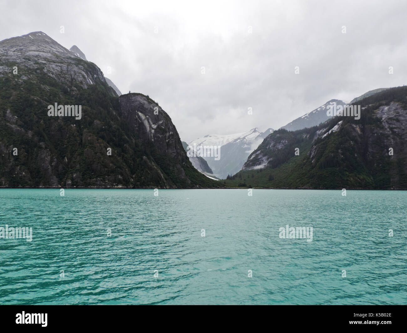 BEAUTIFUL BLUE GLACIAL WATER AND CLIFFS, ALASKA Stock Photo - Alamy