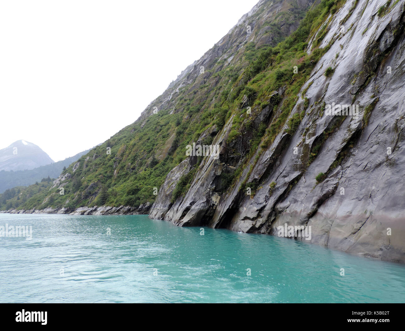 BEAUTIFUL BLUE GLACIAL WATER AND SMOOTH CLIFFS, ALASKA Stock Photo - Alamy