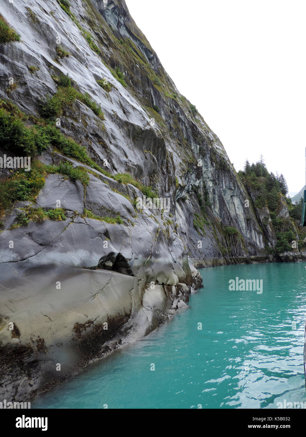 BEAUTIFUL BLUE GLACIAL WATER AND SMOOTH CLIFFS, ALASKA Stock Photo - Alamy