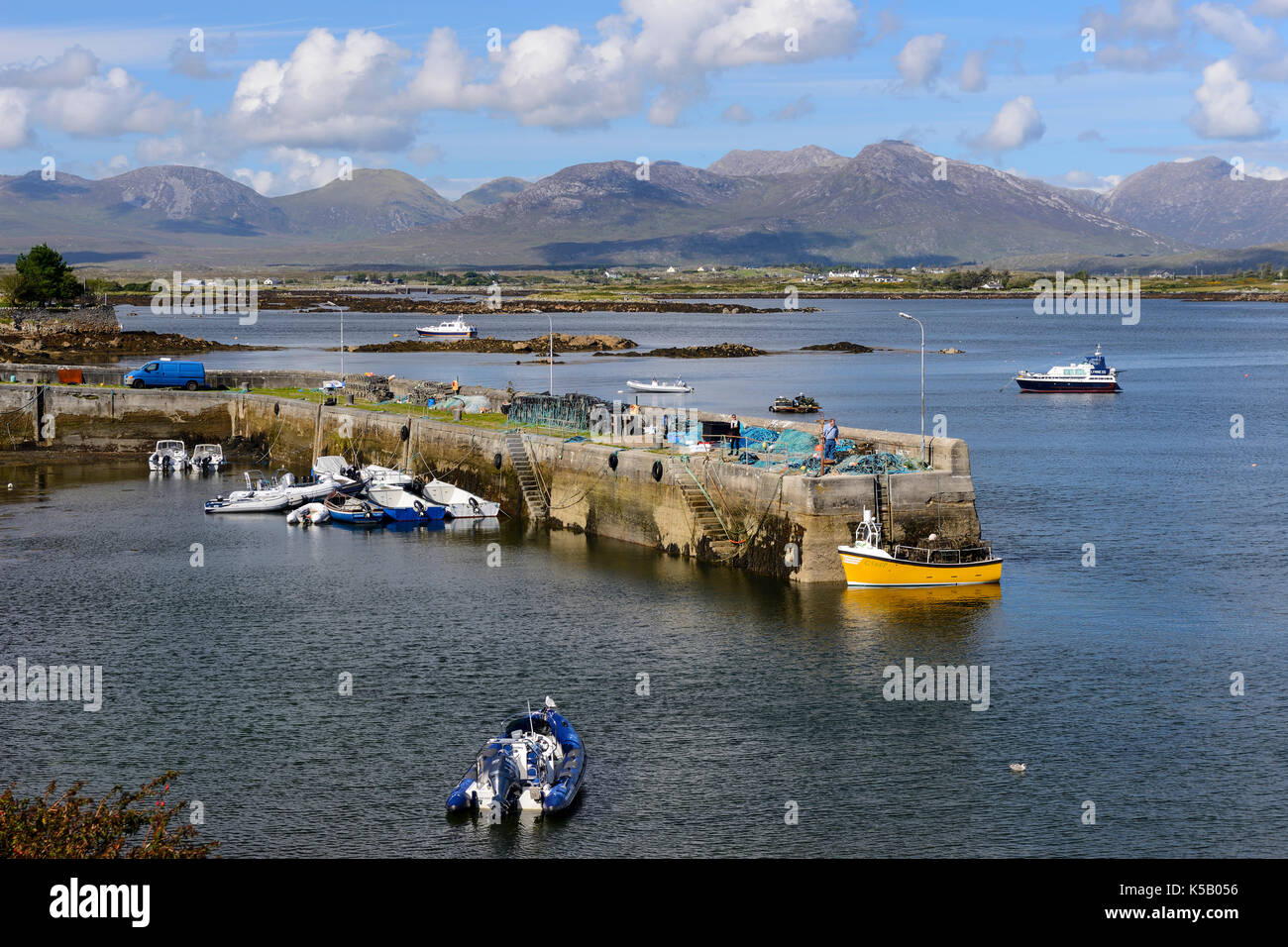 Roundstone harbour with distant view of Twelve Bens Mountain range in ...