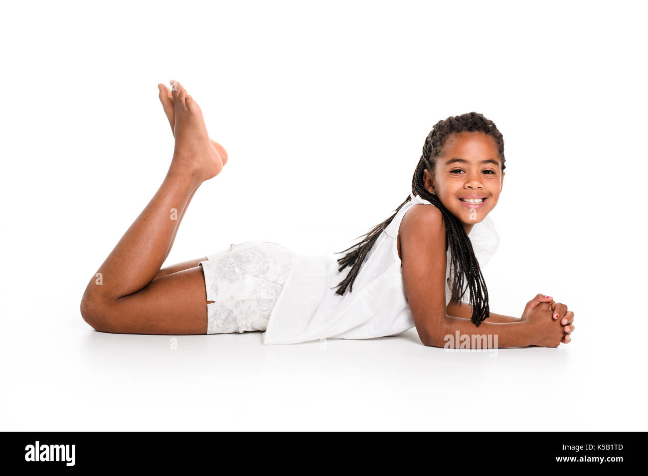 Adorable african little girl on studio white background Stock Photo - Alamy