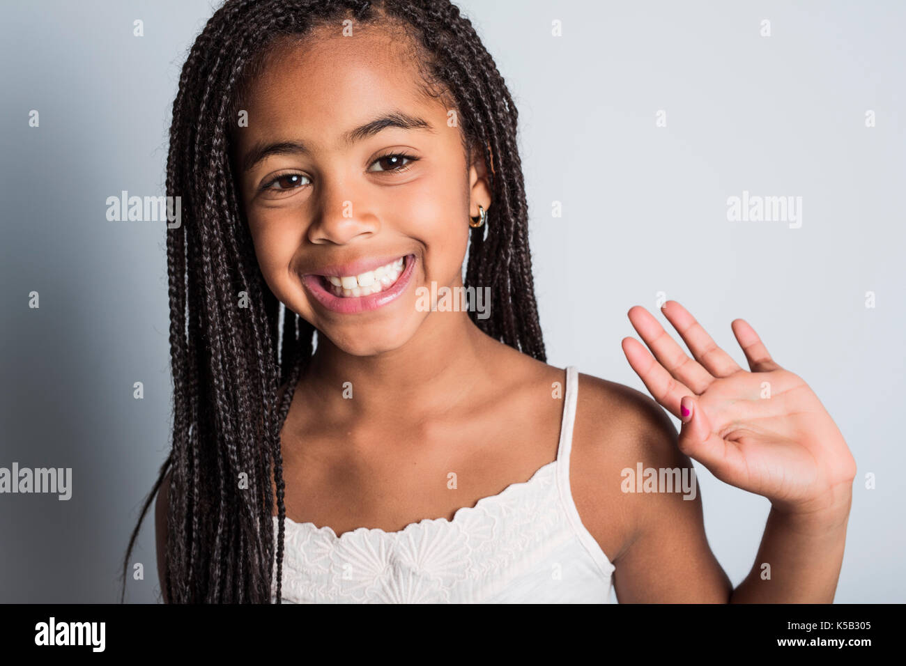 Adorable african little girl on studio gray background Stock Photo - Alamy