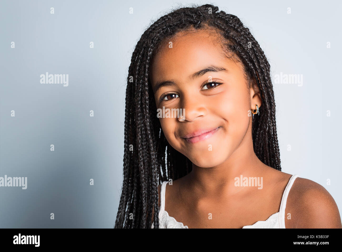 Adorable african little girl on studio gray background Stock Photo - Alamy