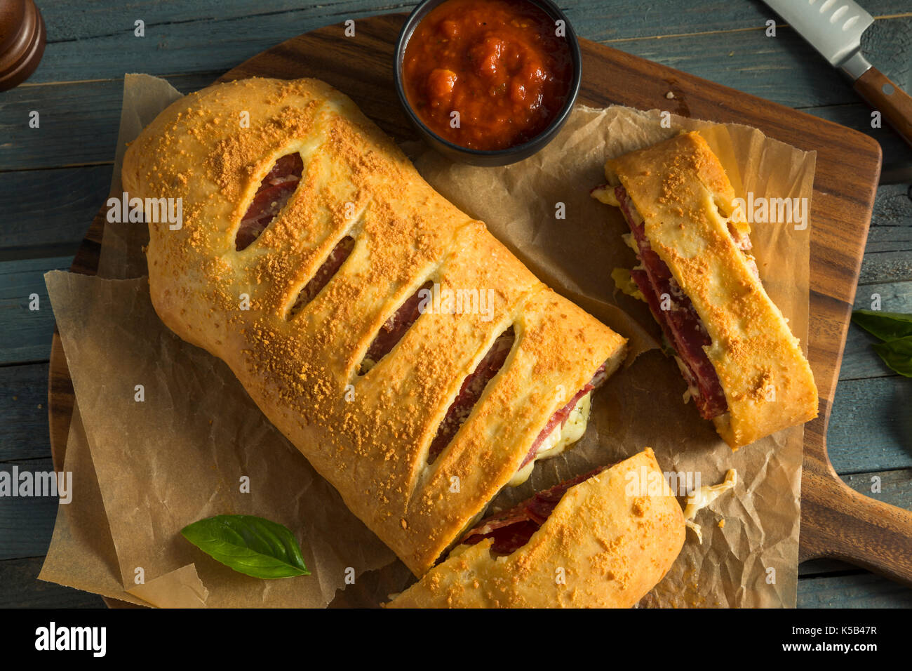 Homemade Cheesy and Meaty Italian Stromboli with Marinara Sauce Stock ...