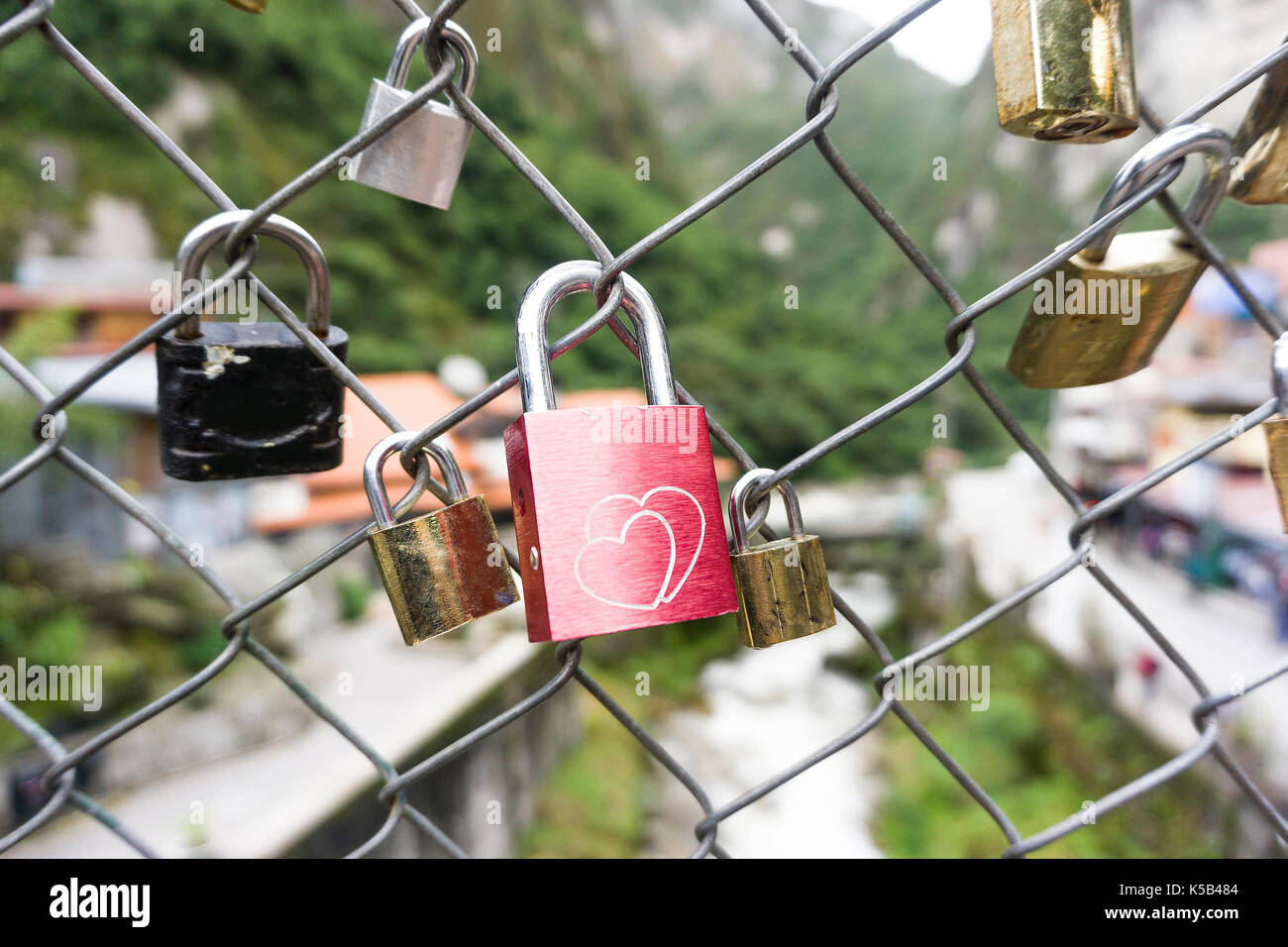 Red heart shaped lock padlock on the fence on the background Stock ...