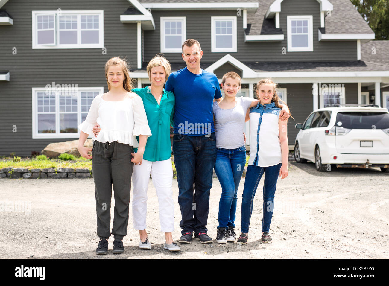 happy family standing in front of the house Stock Photo - Alamy