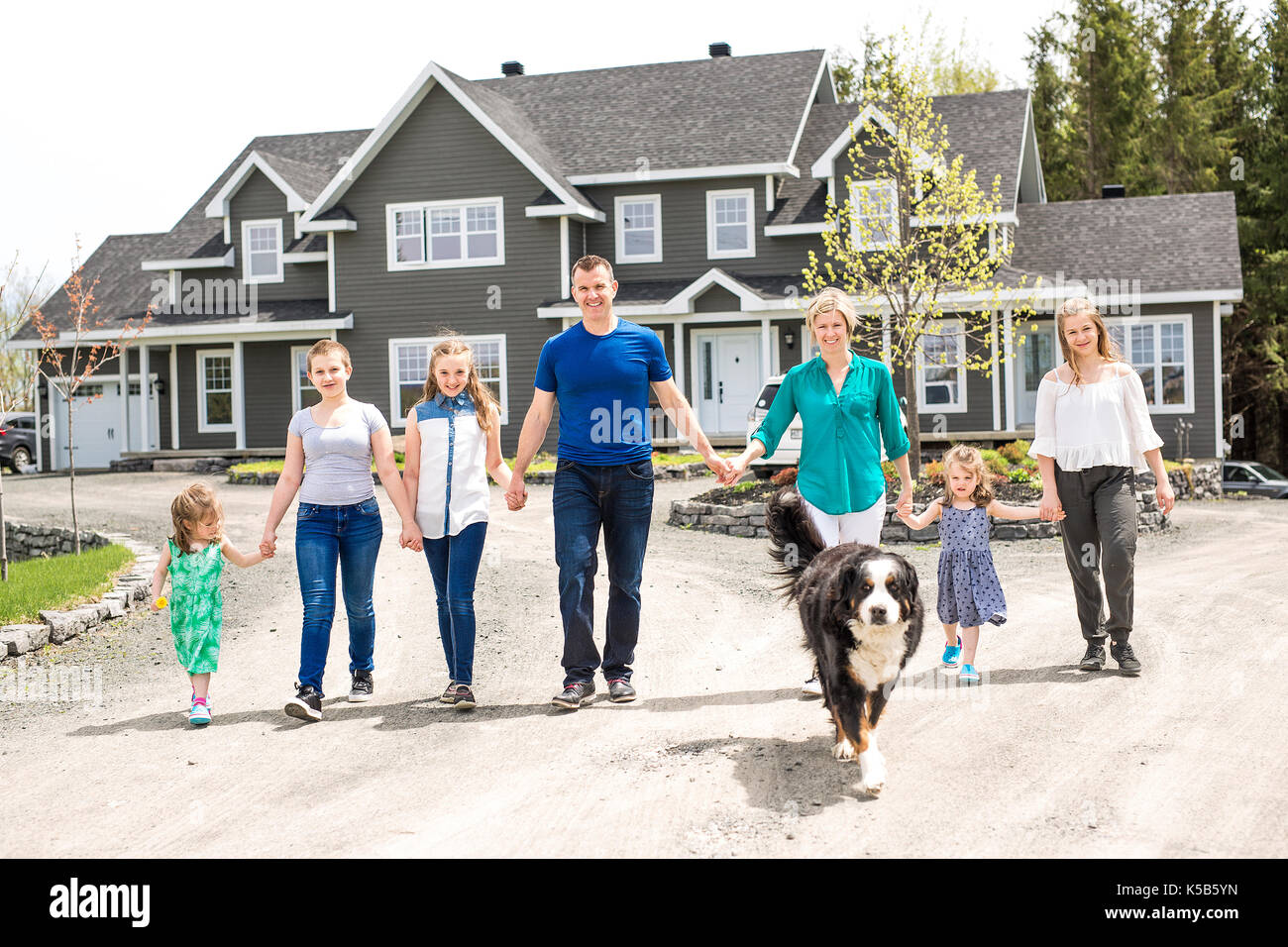 Family In Front Of House