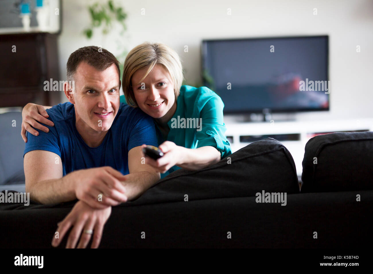 couple looking back in the living room at home Stock Photo - Alamy