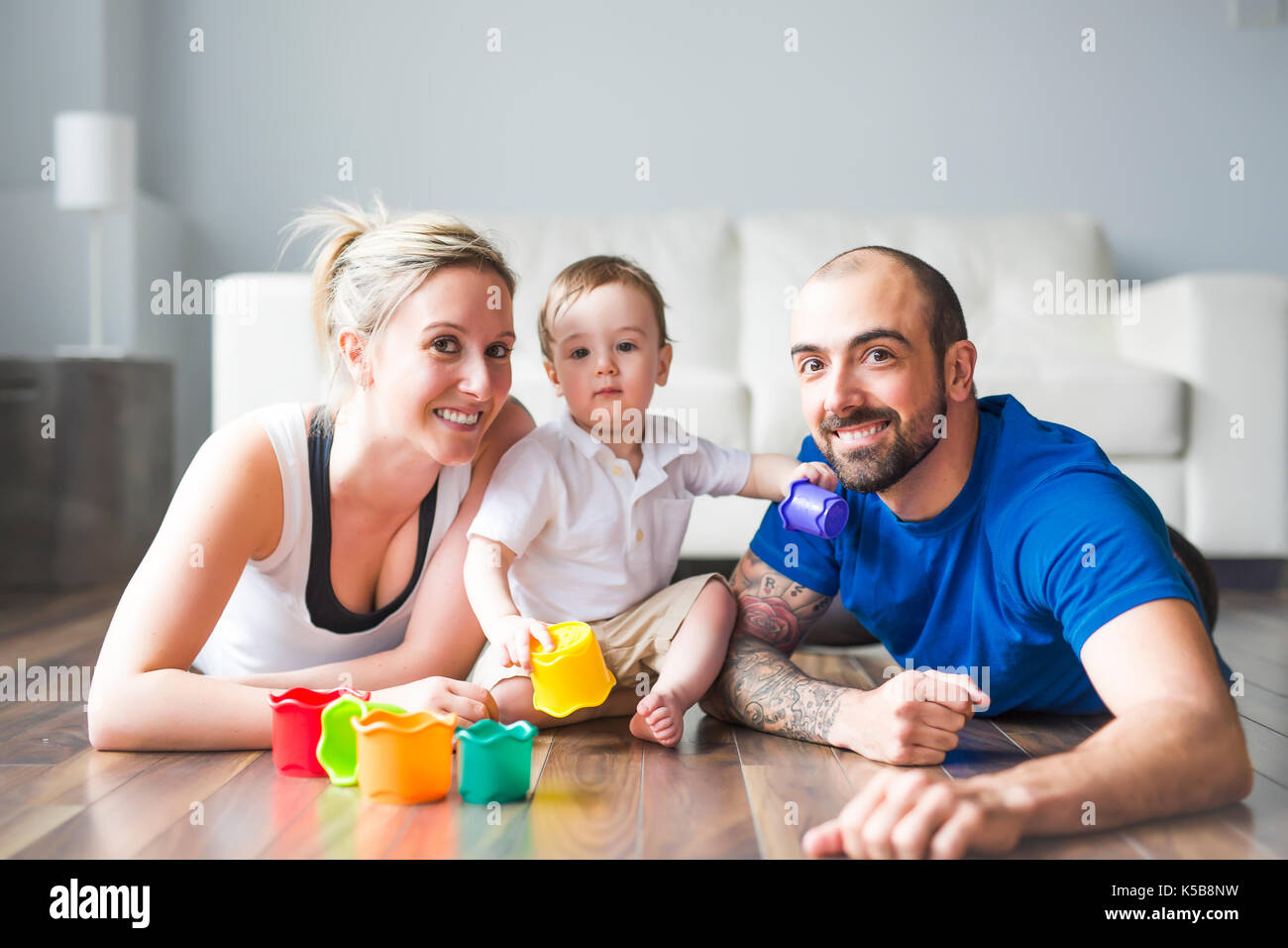 Happy family with parents and son playing with colorful blocks in the ...