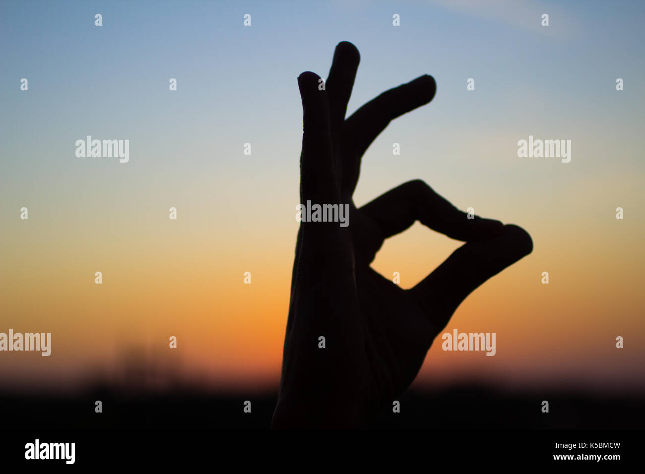 Ok hand sign silhouette at sunset Stock Photo - Alamy