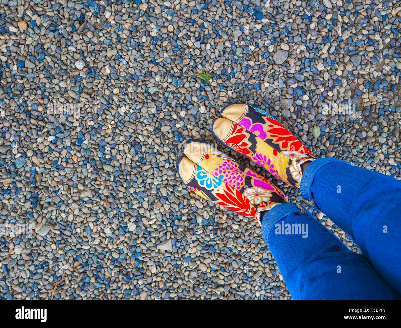 Close up of feet with special japanesse shoes, in a pavement background ...