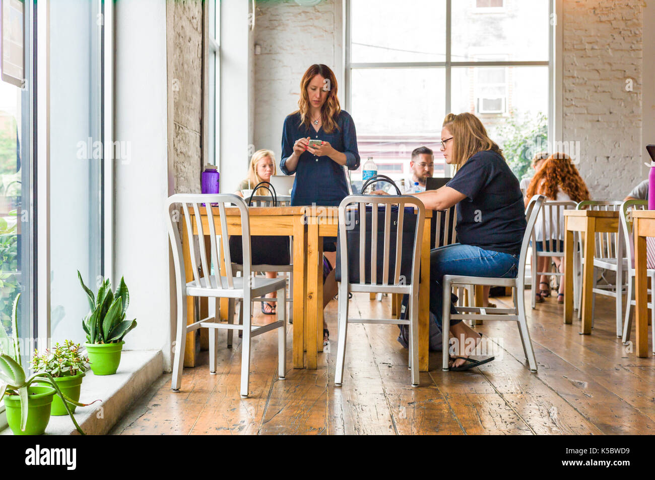 Patrons at a coffee shop in a large metropolitan city Stock Photo - Alamy